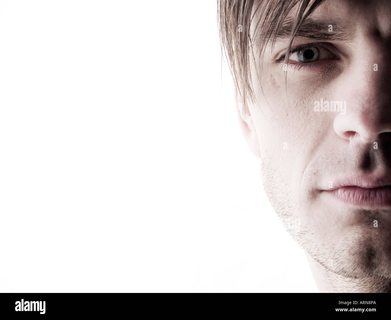 Portrait of a young serious man Stock Photo - Alamy