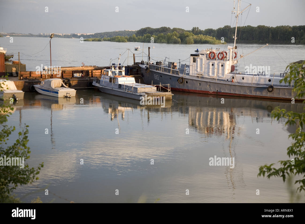 Boats including a naval launch moored on the river Ob in Novosibirsk ...