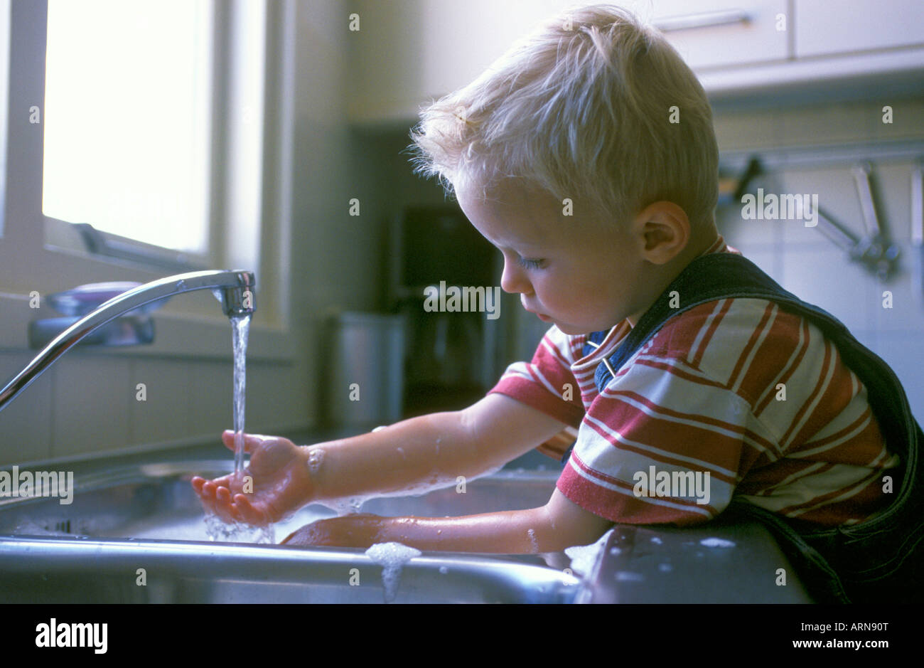 Little boy is washing his hands Stock Photo - Alamy