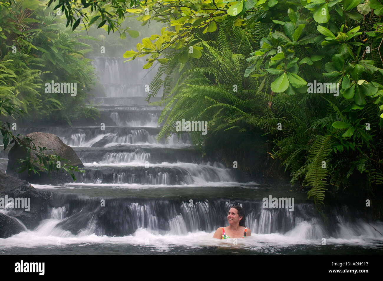 A visitor enjoys one of the warm streams that flows through Tabacon Hot ...