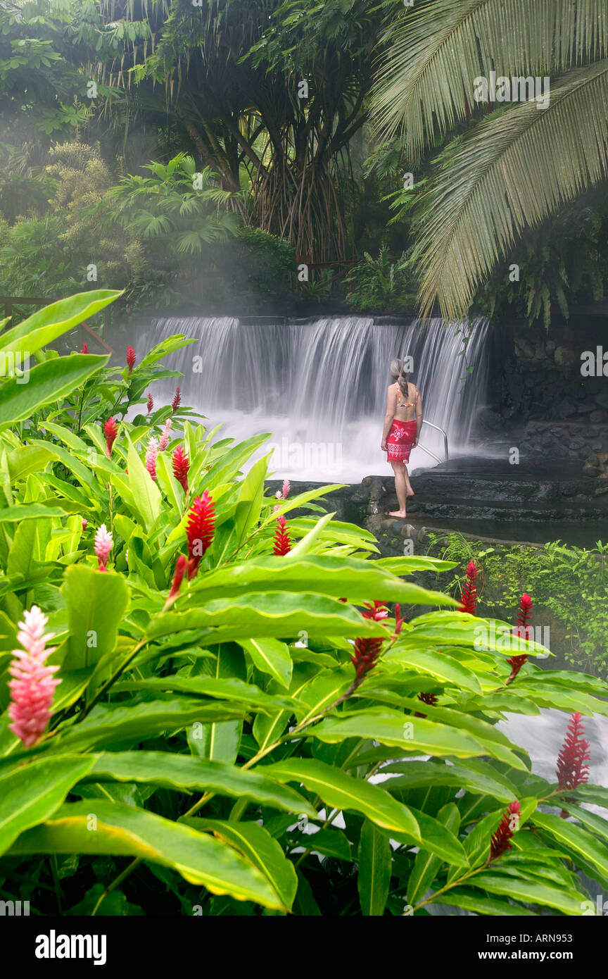 A visitor enjoys a hot water stream flows through Tabacon Hot Spring ...
