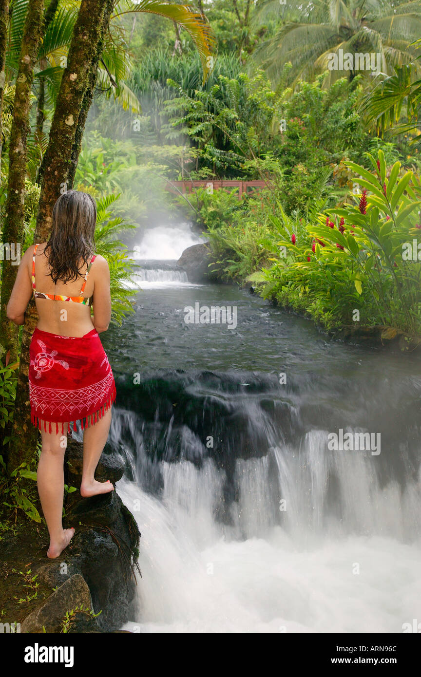 A visitor enjoys a hot water stream flows through Tabacon Hot Spring ...