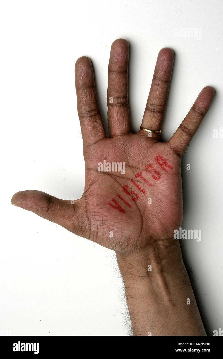 Coloured hand with Visitor stamp Stock Photo - Alamy