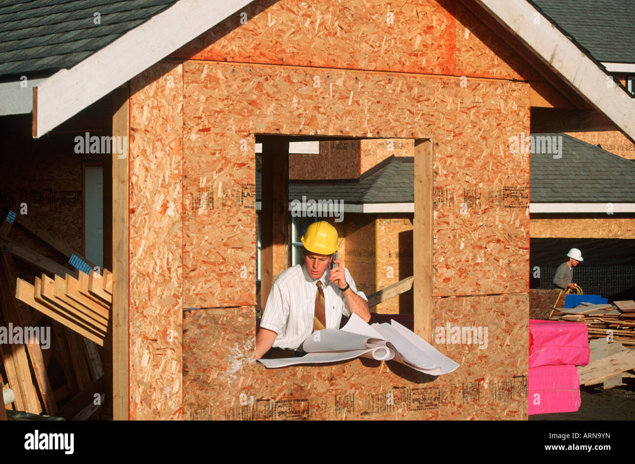 Architect framed through opening on construction site, British Columbia ...