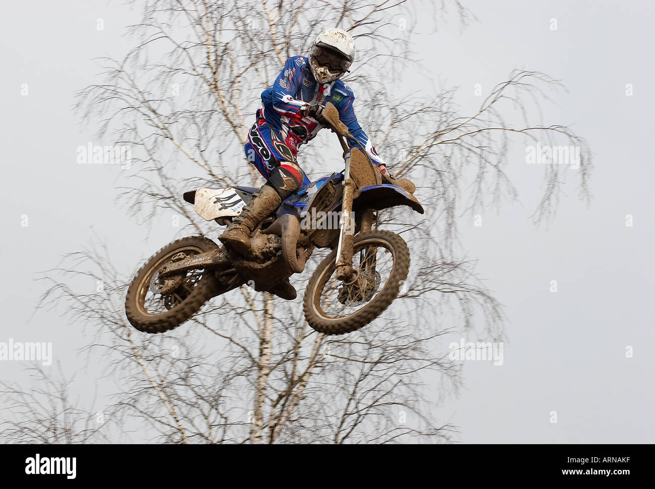Jumping motocross driver Stock Photo - Alamy