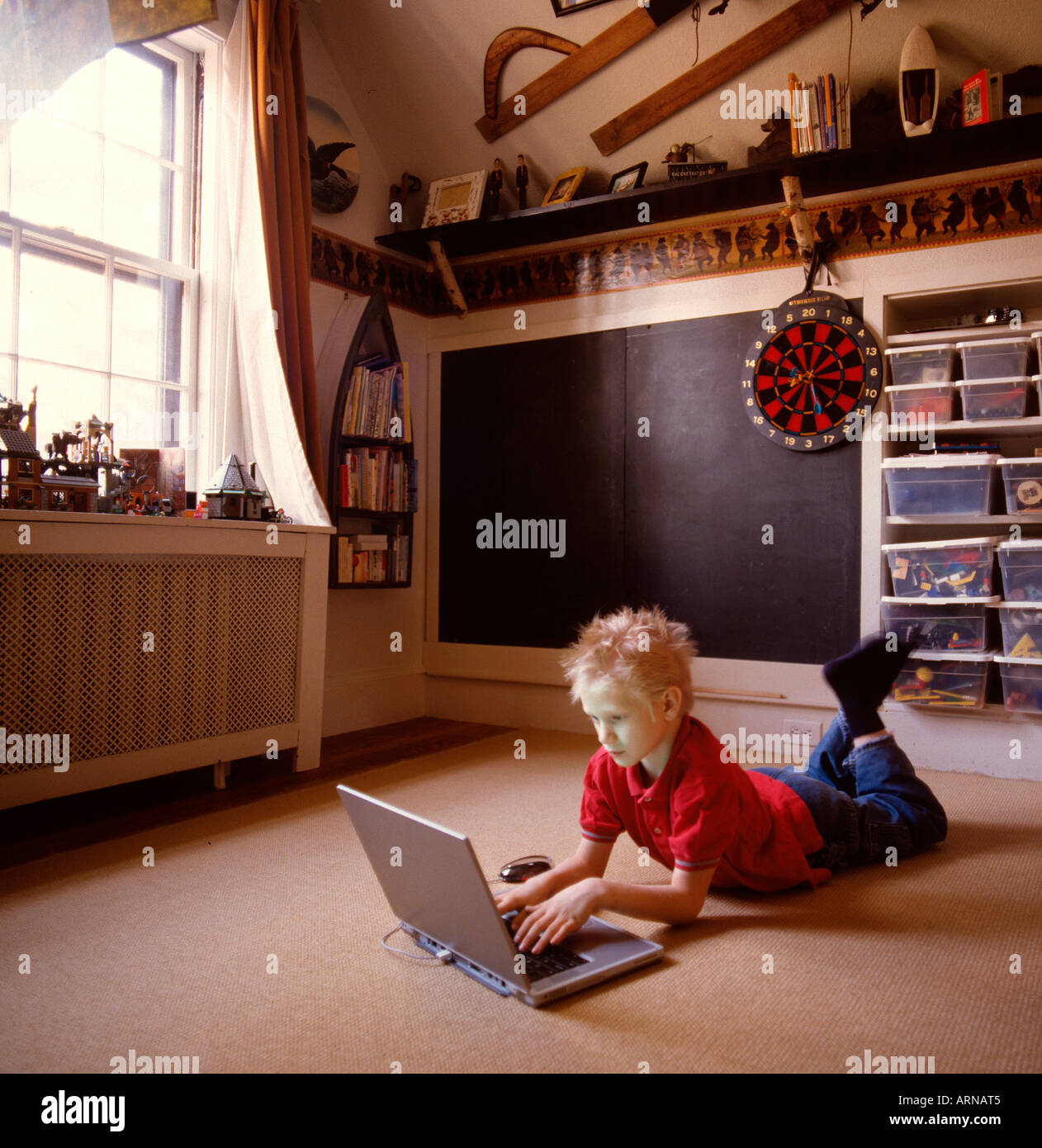 Young boy working on laptop computer Stock Photo - Alamy