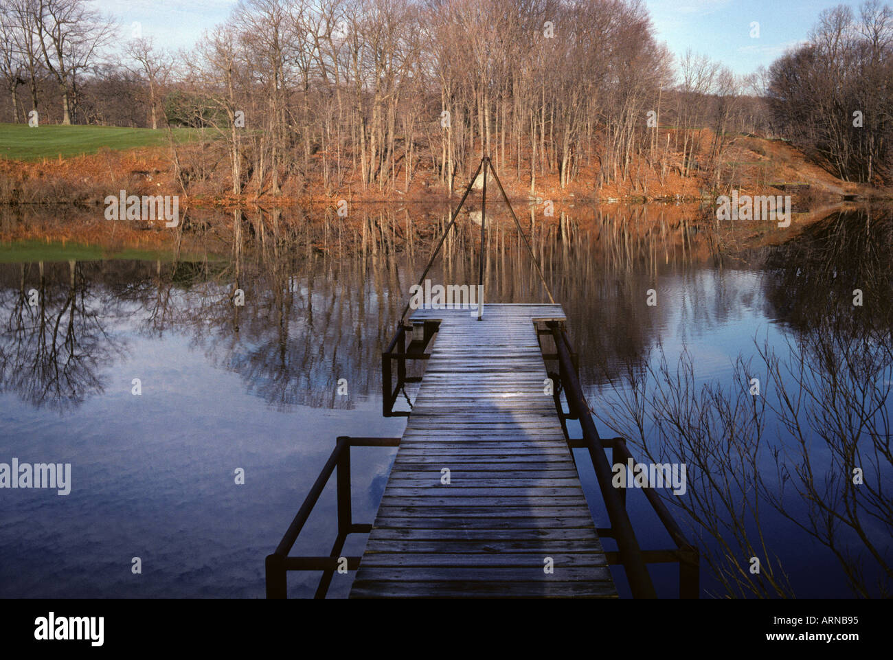 A still pond with dock landscape Stock Photo - Alamy