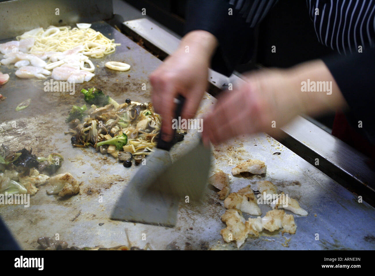 Chinese chef cooking food on a hot ladle grill Stock Photo - Alamy