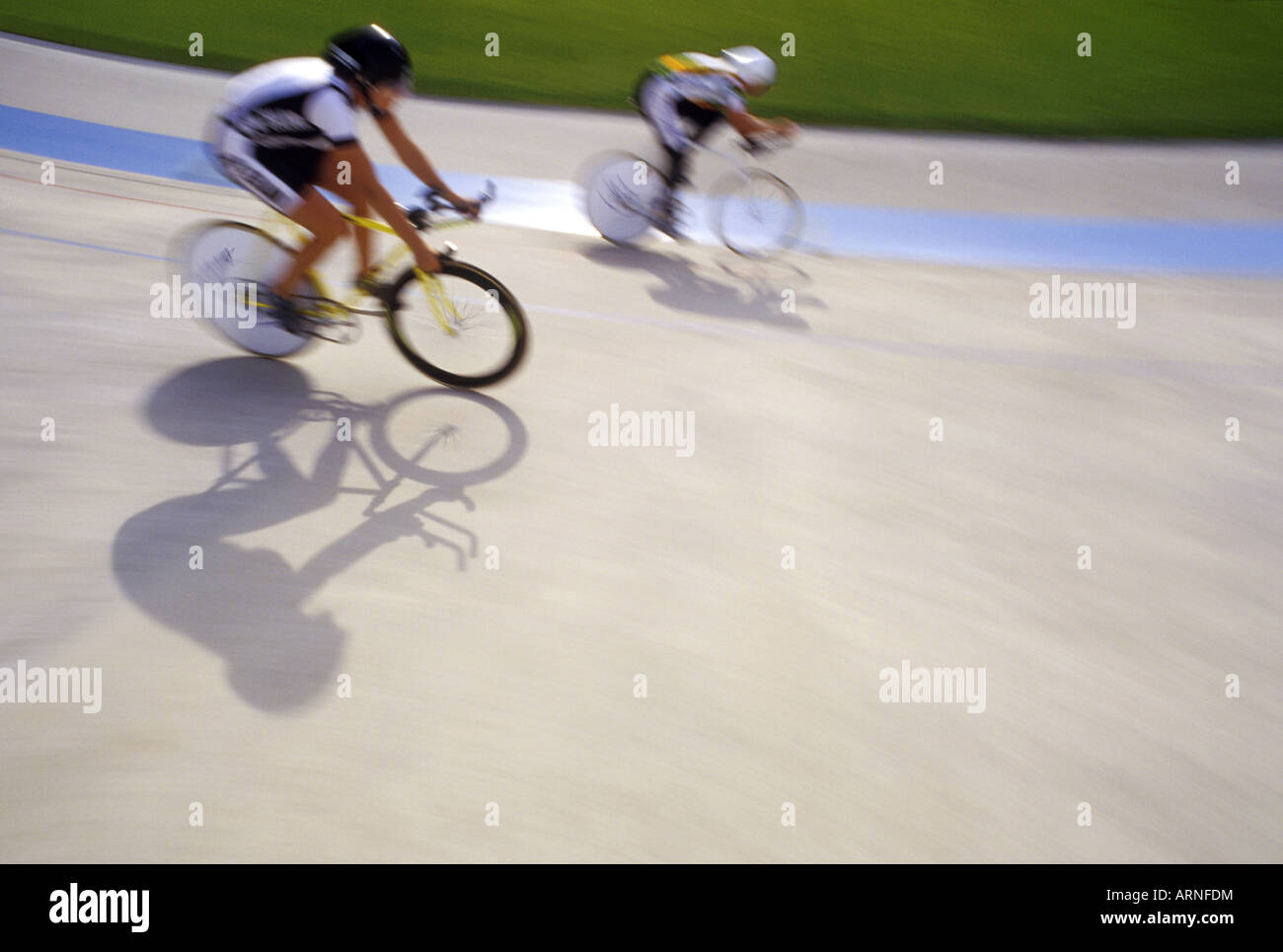 Bicycle racers on velodrome track with graphic shadows, British ...