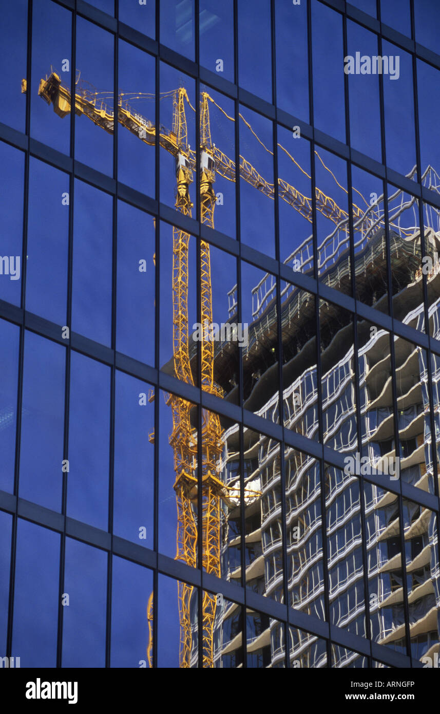 New high rise building under constrution reflected in glass of building ...