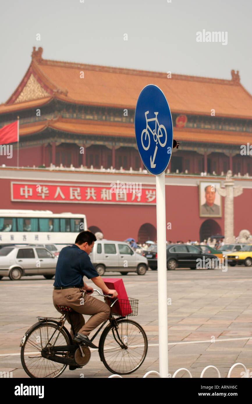 Man riding a bicycle past the Forbidden City in Beijing China Stock ...