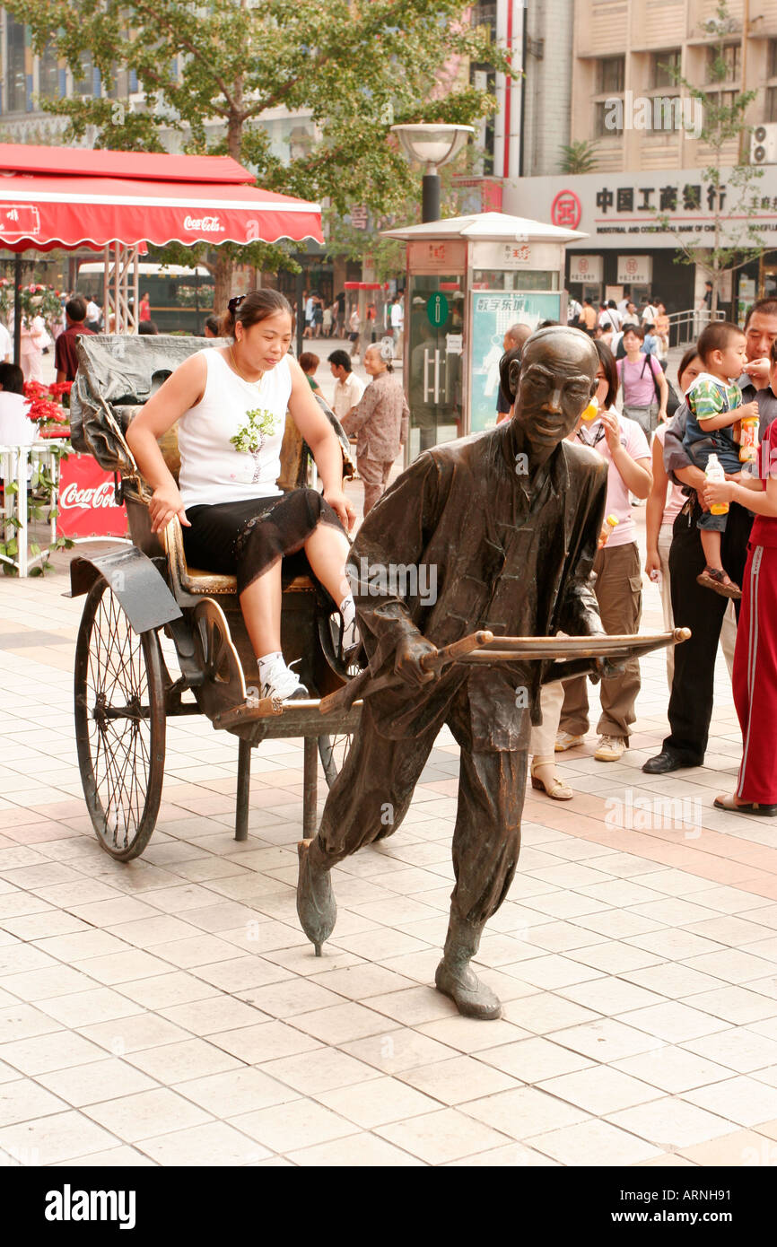 Statue of old rickshaw driver in Wangfujing Dajie shopping street in ...