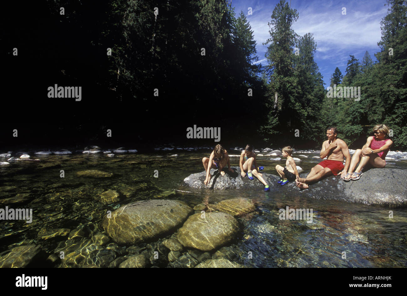 Englishman River Provincial Park. Family swimming and sunning on rocks ...
