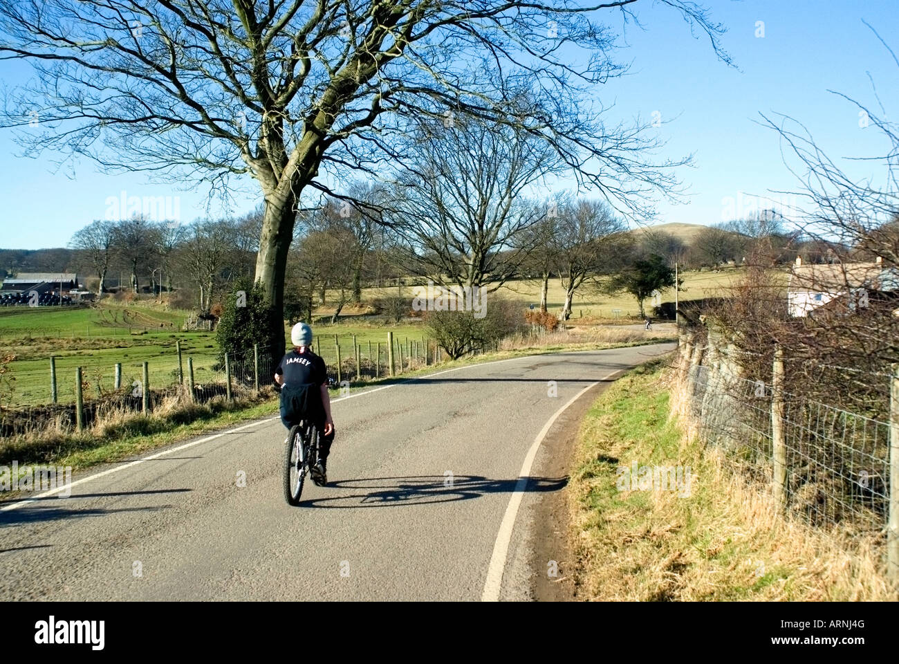 boy cycling on country lane manmoel high above the ebbw valley gwent ...
