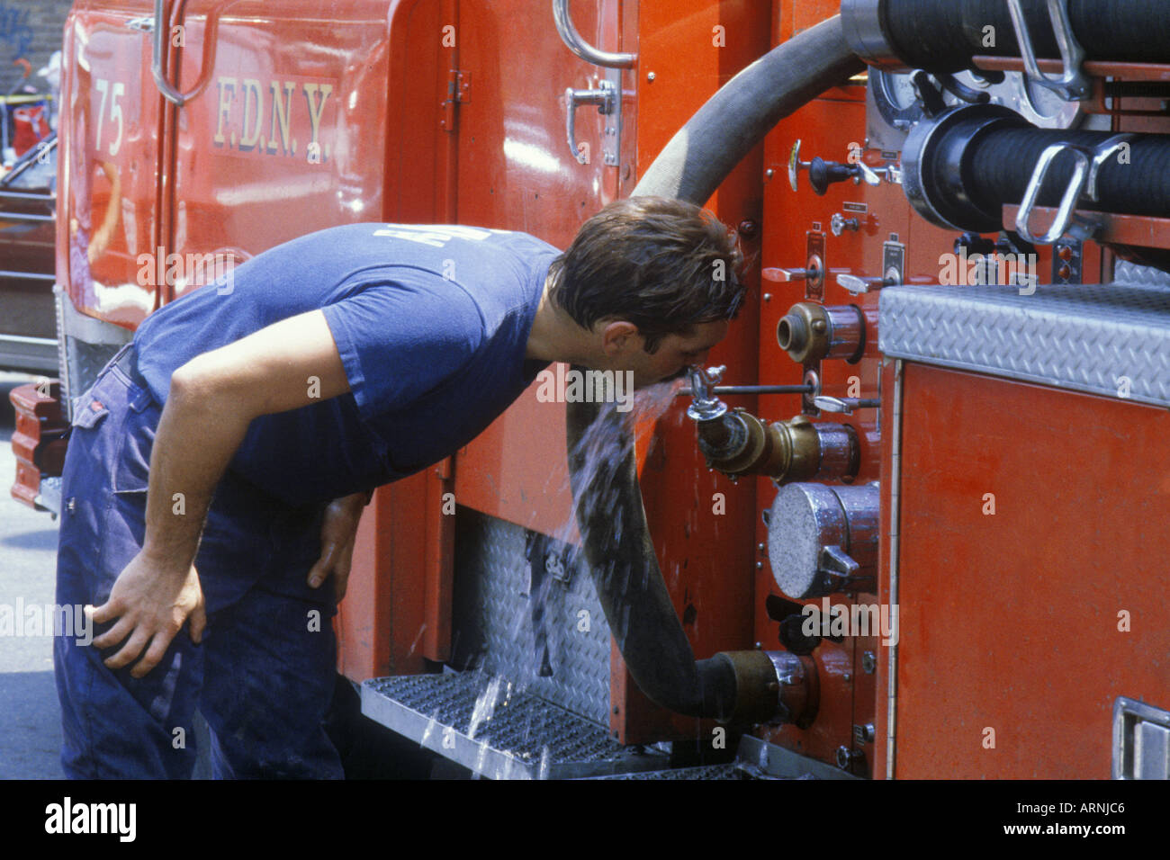 Dehydrated fireman after fighting fire. Thirst. Firefighter drinking ...