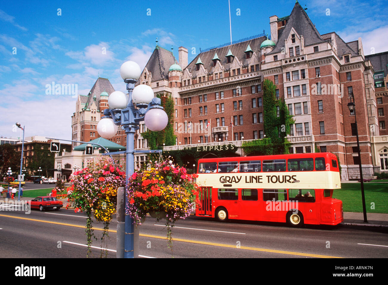 Double decker bus parked in front of the Empress Hotel with flower ...