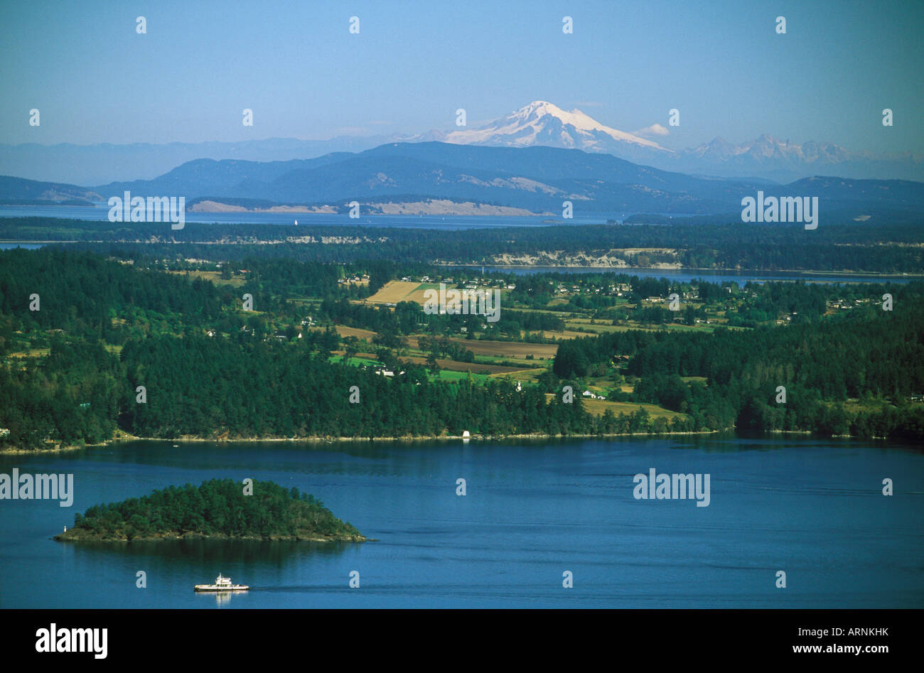 Mill Bay ferry sailing past Saanich Peninsula with Mt. Baker beyond ...