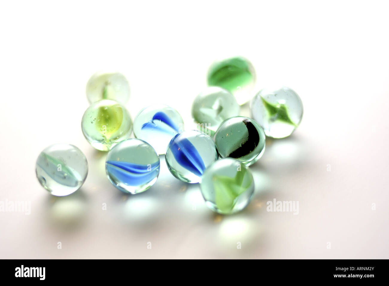 Eleven glass marbles with coloured swirls on a white background Stock ...