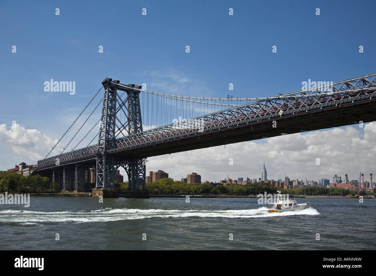 Fishing Boat passing under the western tower of the WILLIAMSBURG BRIDGE ...