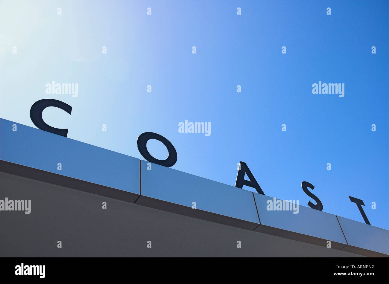 The word coast on top of a building with a beautiful blue sky ...