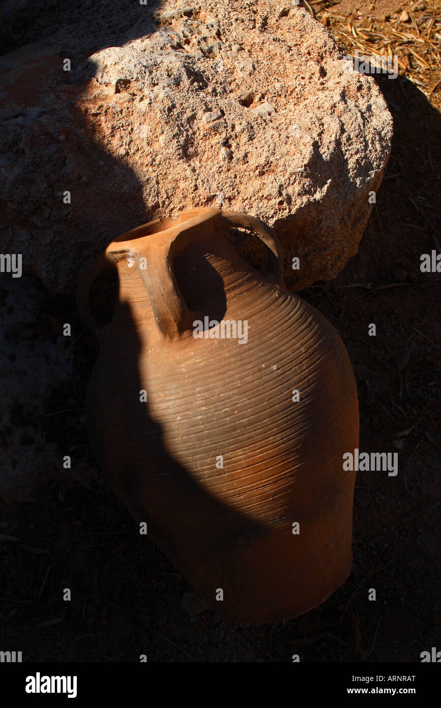 An old Greek pot lying against a rock Lindos Rhodes Greece Stock Photo ...