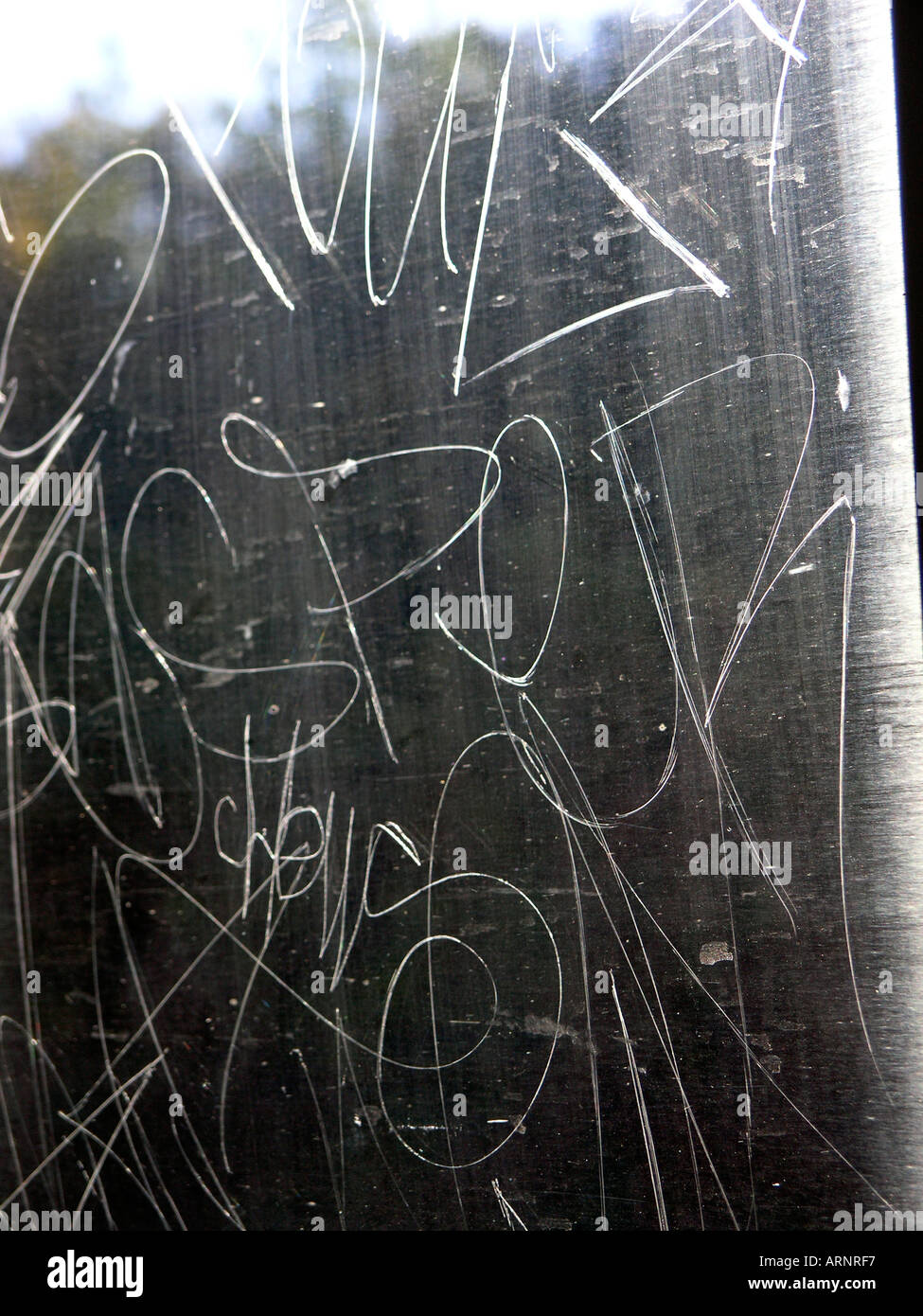 Railway carriage window with graffiti scratched onto it London England ...