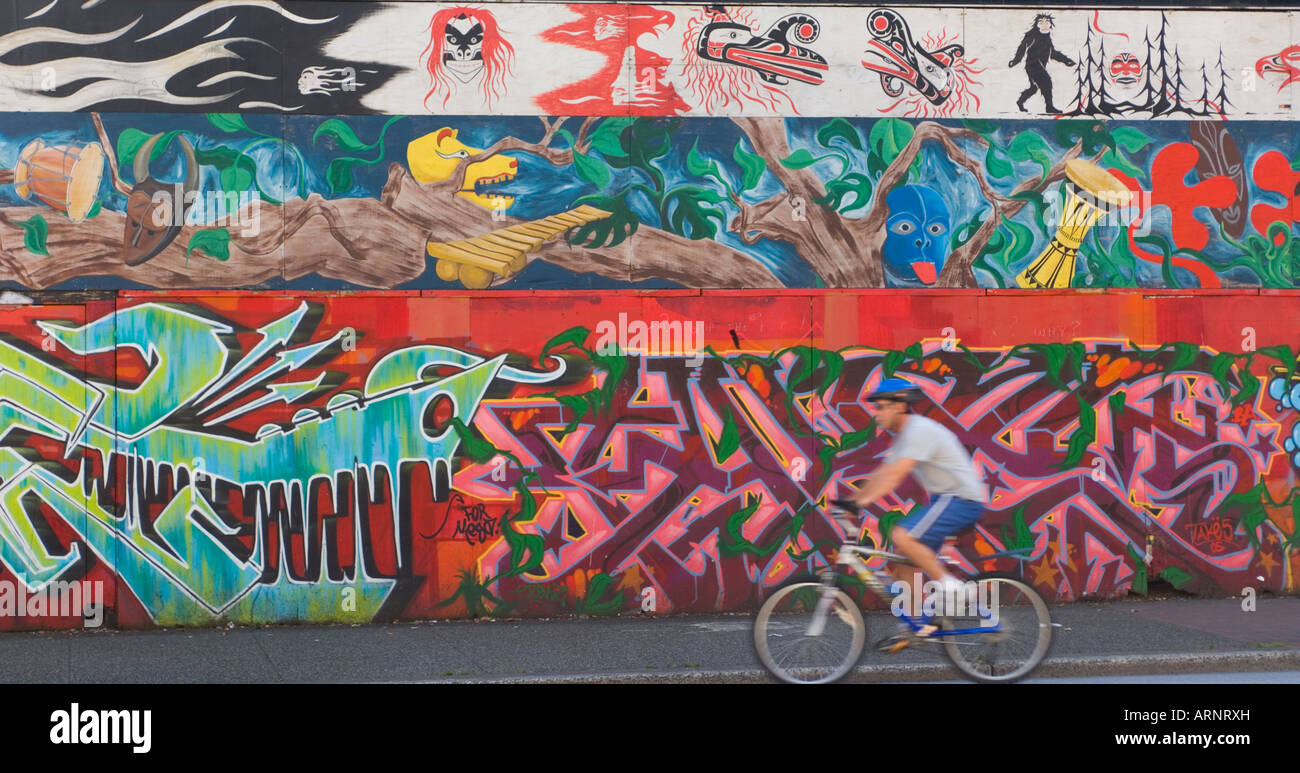 Cyclist in front of graffiti mural, east Vancouver, British Columbia ...