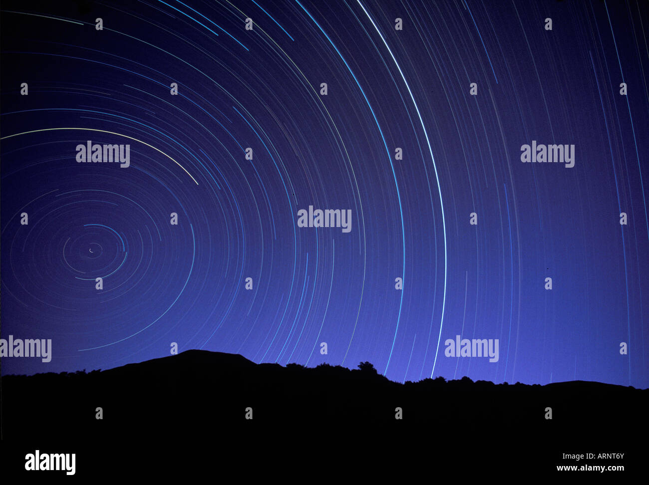 Star trails over mountain range in utah Stock Photo - Alamy