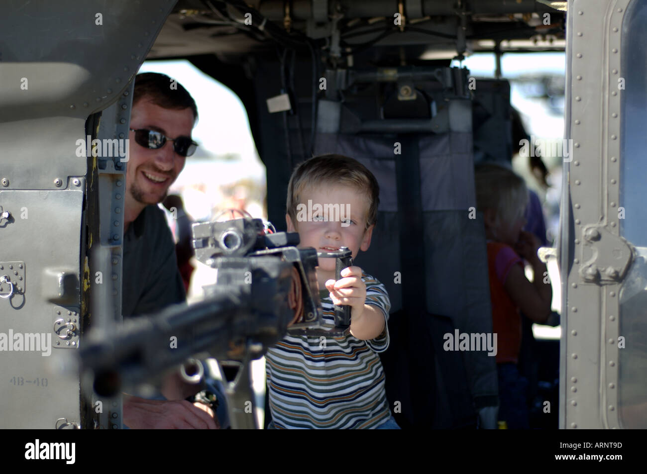 Young American boy playing with machine gun mounted on the side of ...