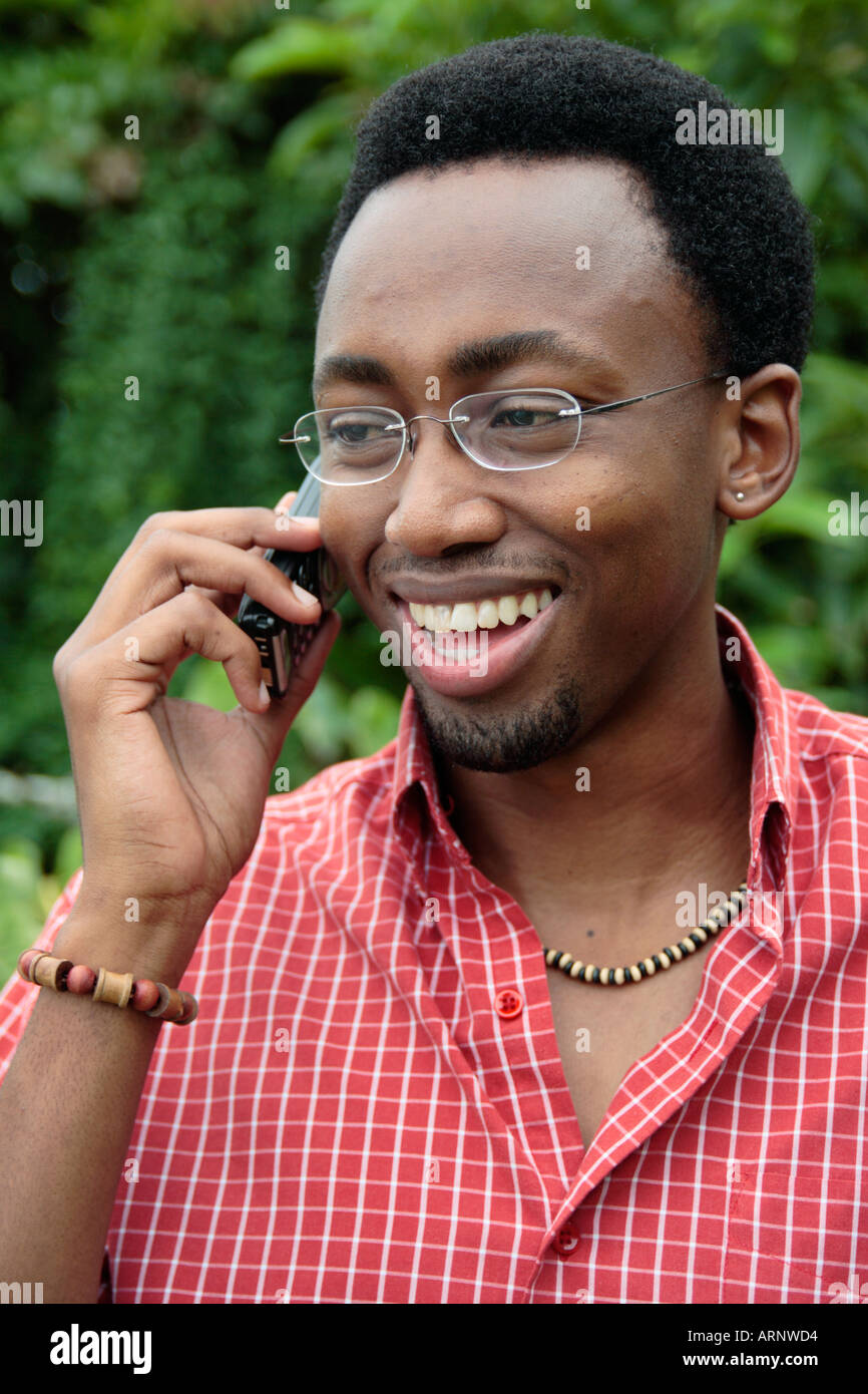 Single black African male laughing on mobile cell phone Stock Photo - Alamy
