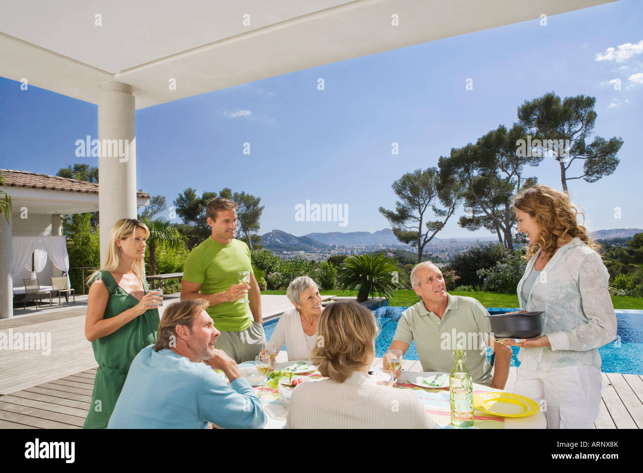 Family eating by poolside Stock Photo - Alamy