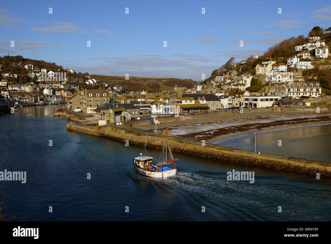 A fishing boat coming back to port at Looe in Cornwall UK Stock Photo ...