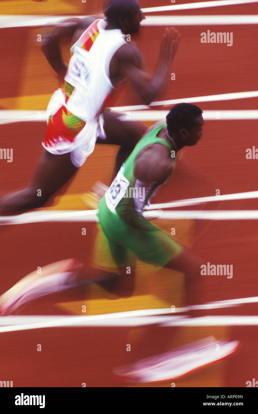 Two sprinters in motion blur on rust colored track Stock Photo - Alamy