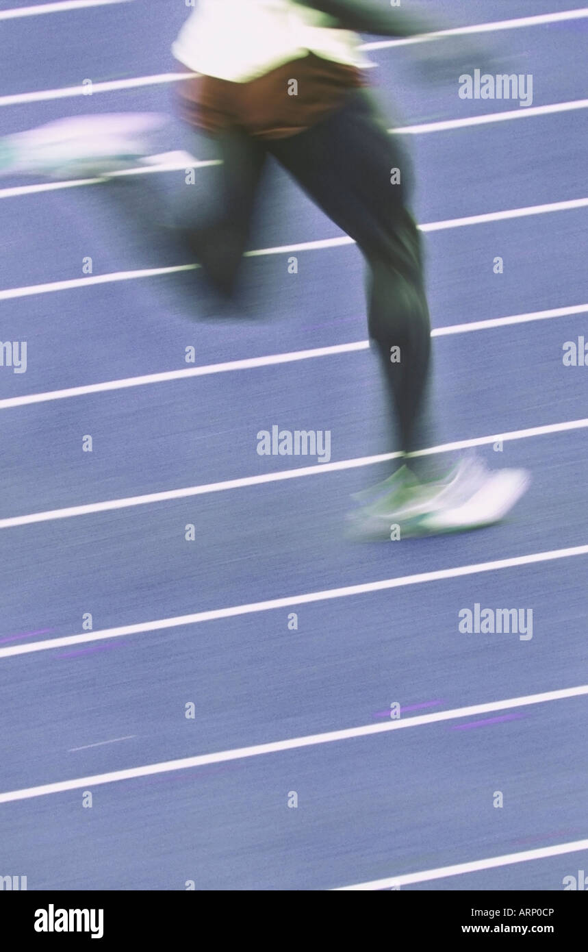 Single sprinter runs on blue track Stock Photo - Alamy