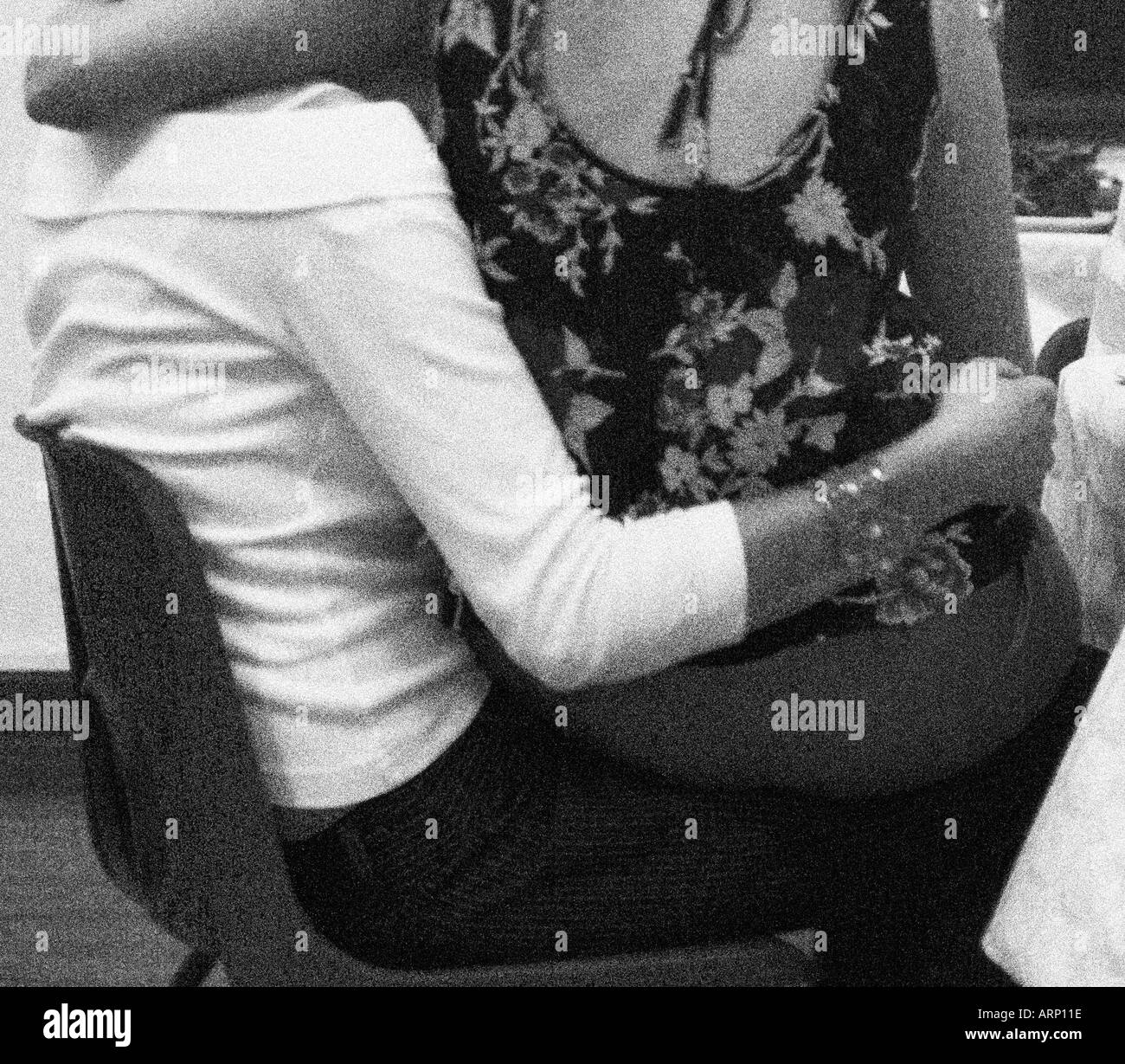 couple with arms around each other Stock Photo - Alamy