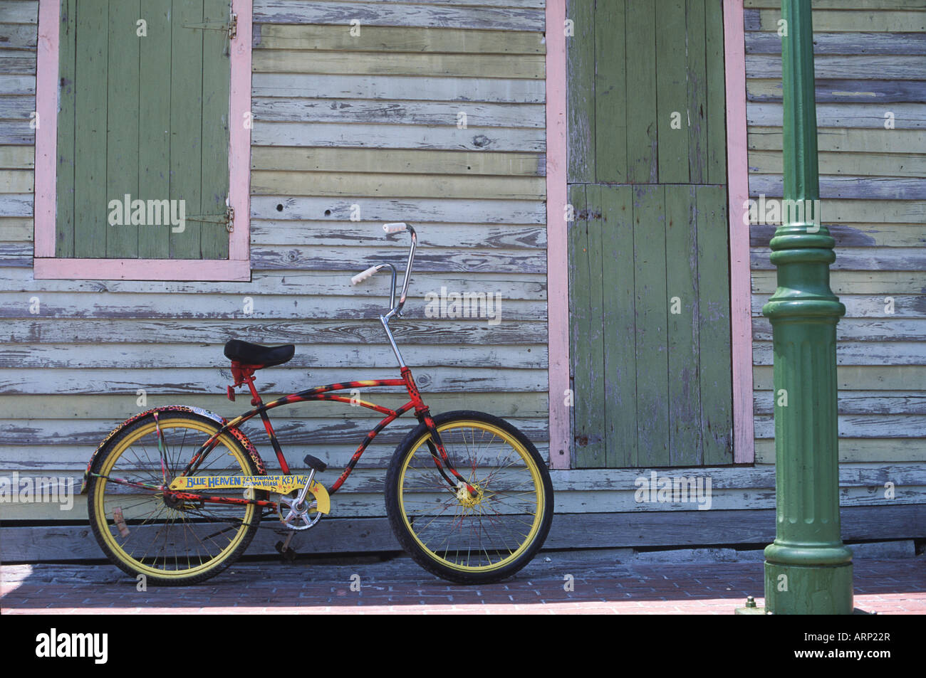 USA, Florida, Key West, cruising bike with custom paint leans on wall ...