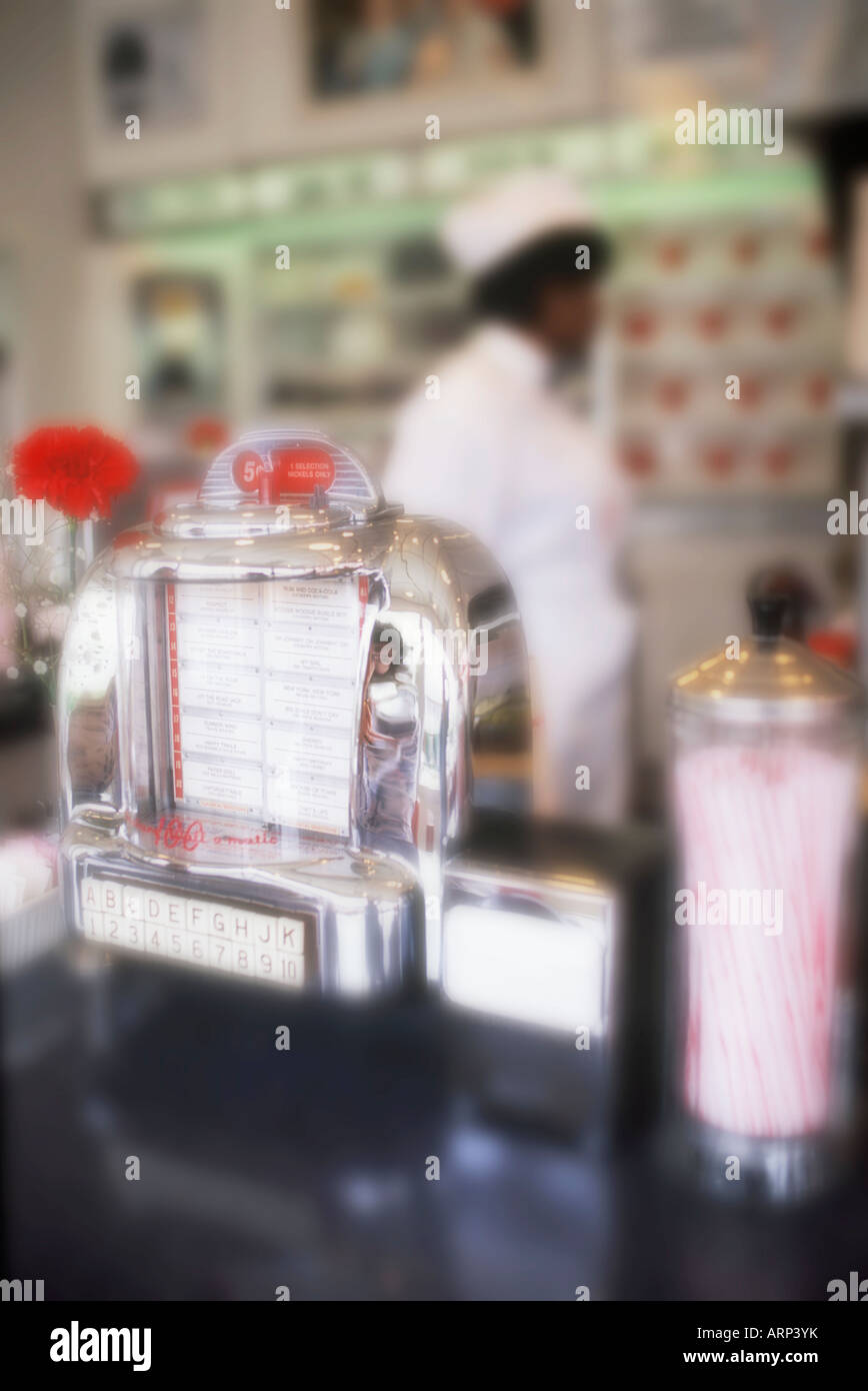 Typical US Diner, close up of juke box on counter, server behind ...