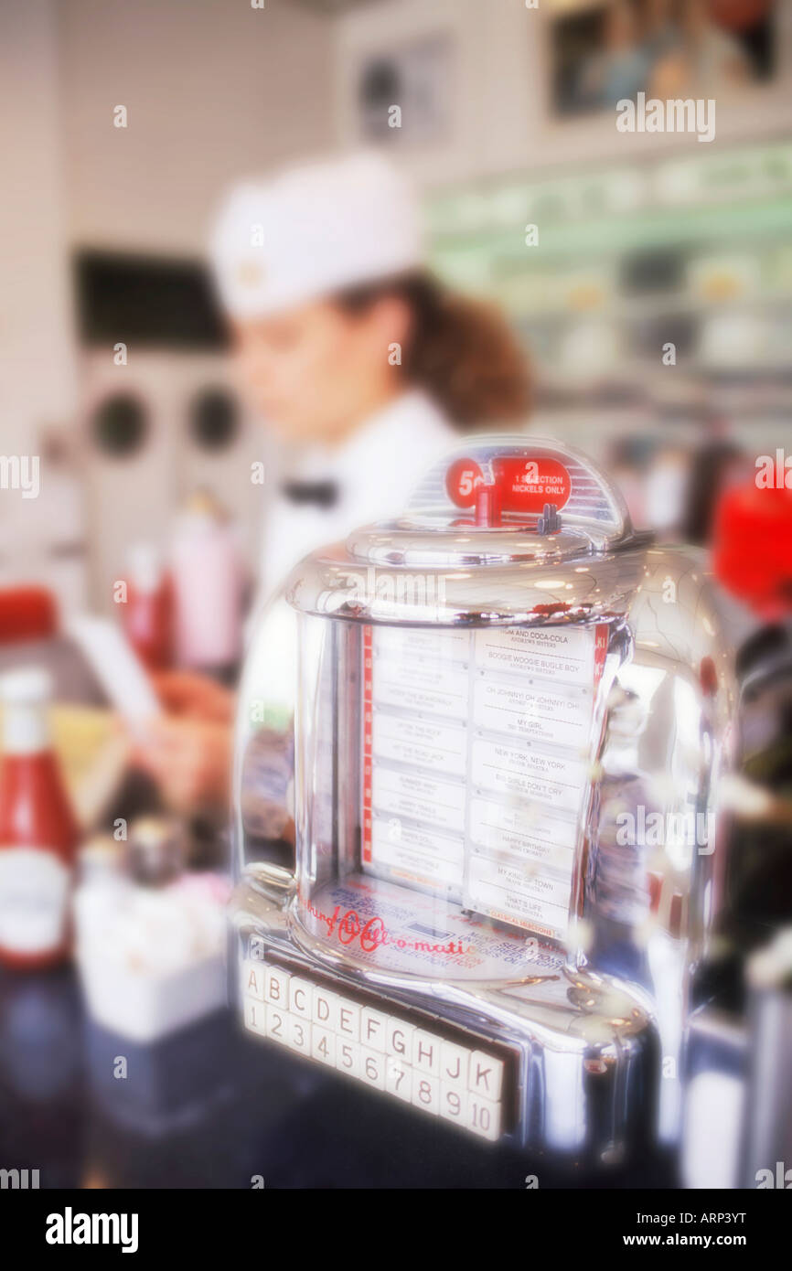 Typical US Diner, close up of juke box on counter, server behind ...