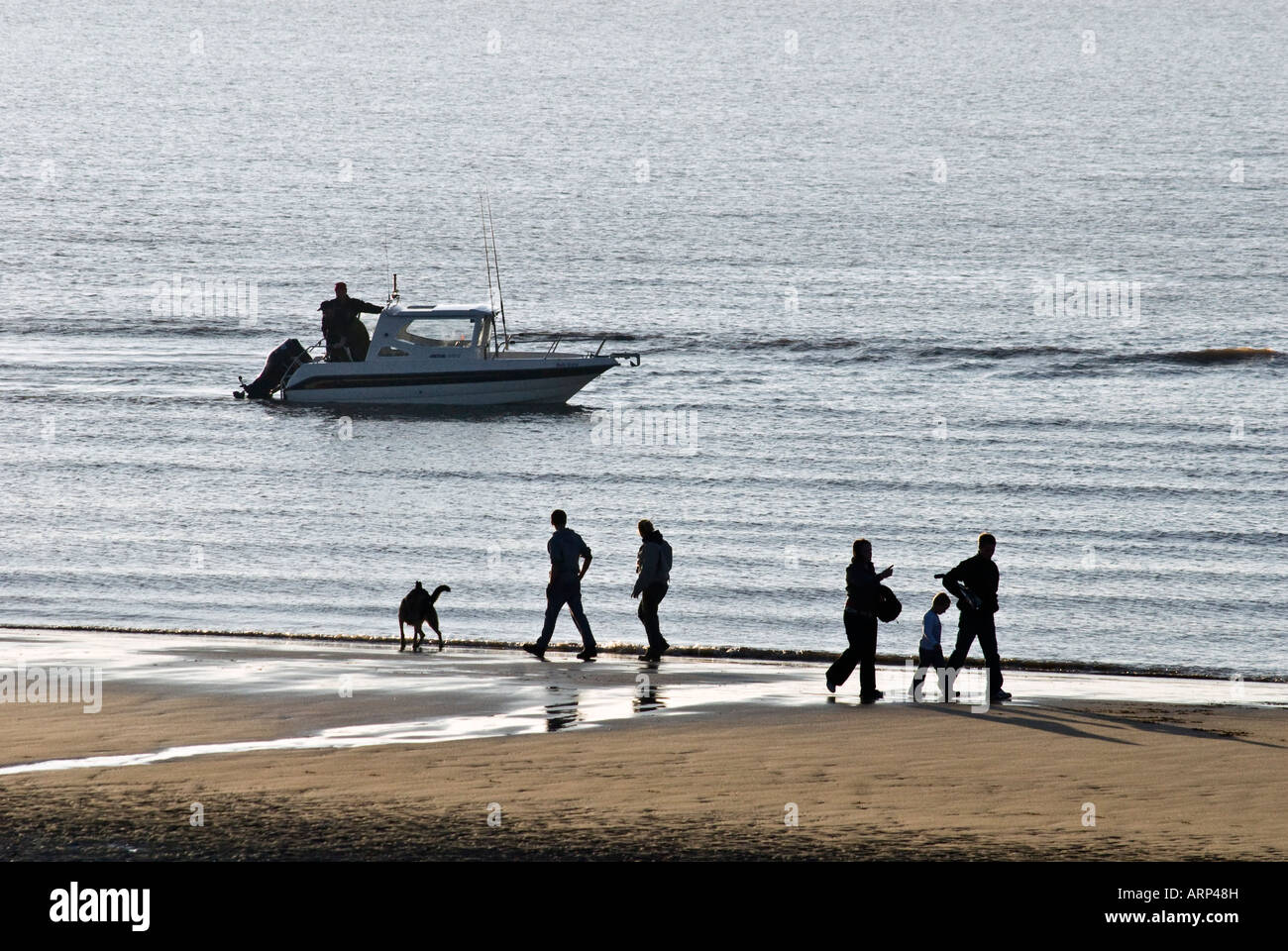 View family walkers beached boat Stock Photo - Alamy