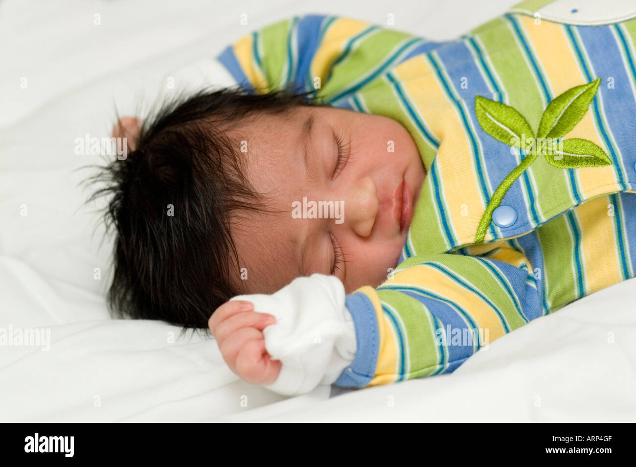 Newborn baby girl stretching Stock Photo - Alamy