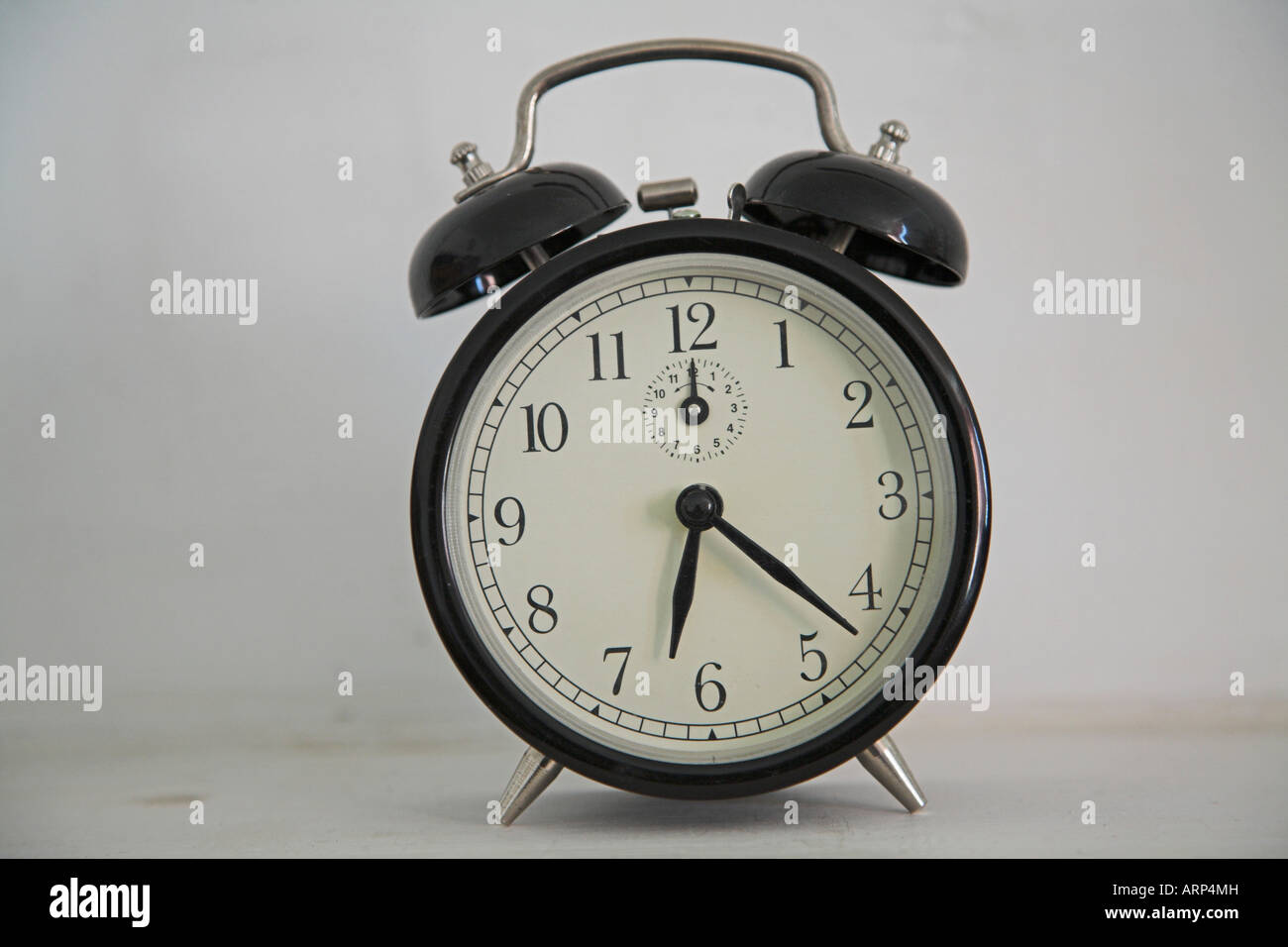 Old fashioned alarm clock white background Stock Photo - Alamy