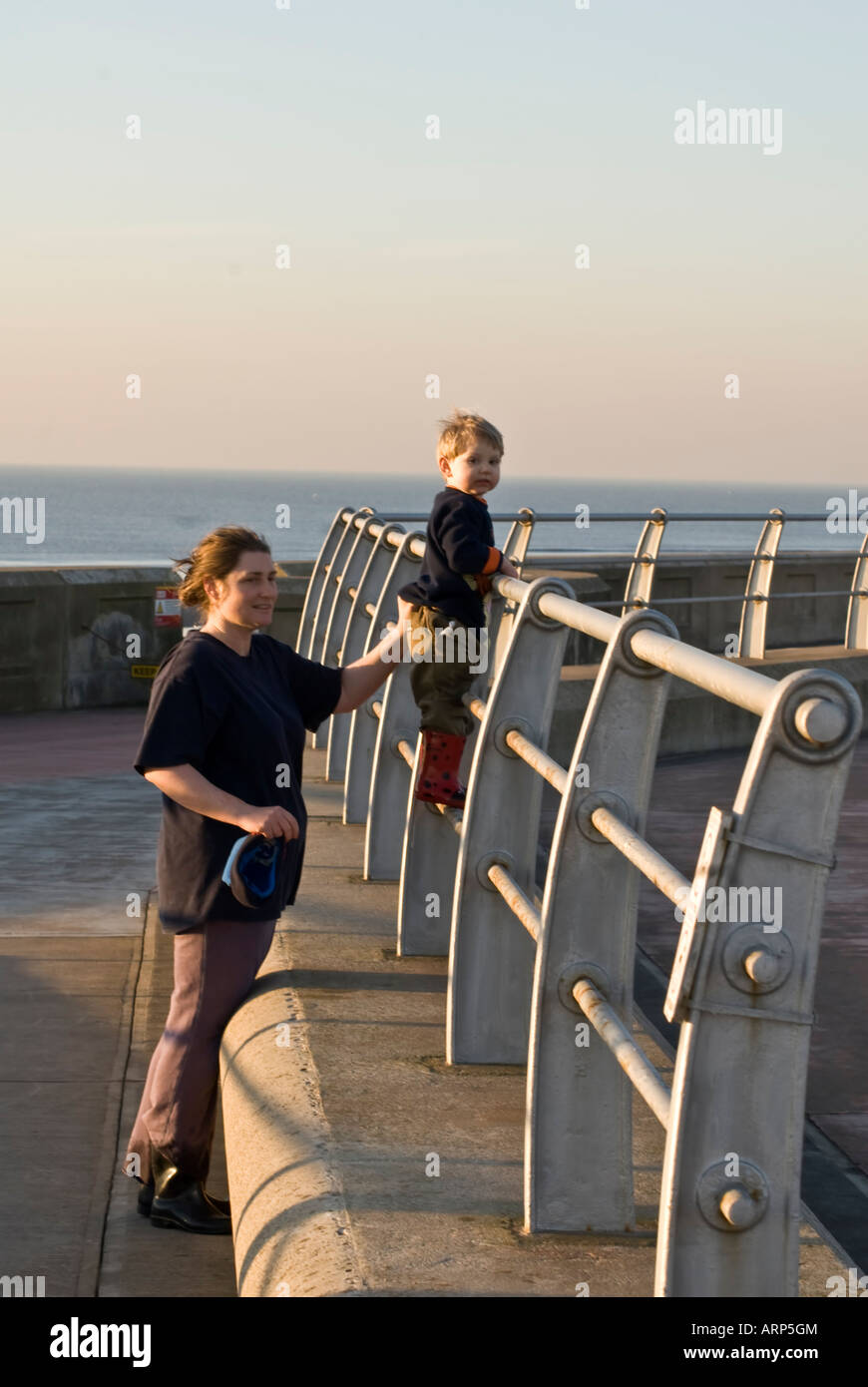 Child climbing railings childs - play Stock Photo - Alamy