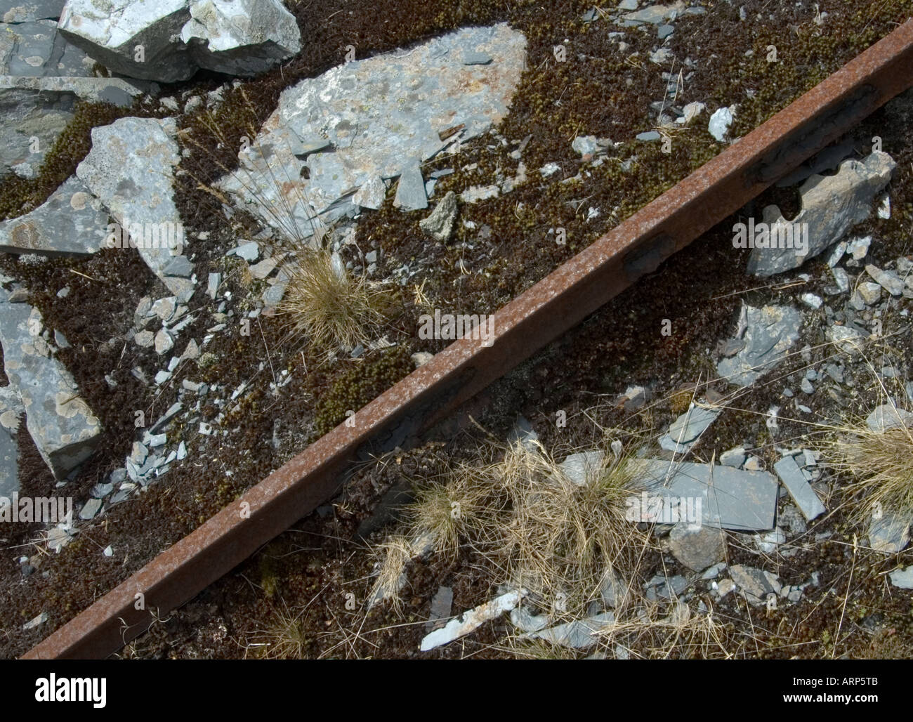 Disused railway track laying between discarded slates Stock Photo - Alamy