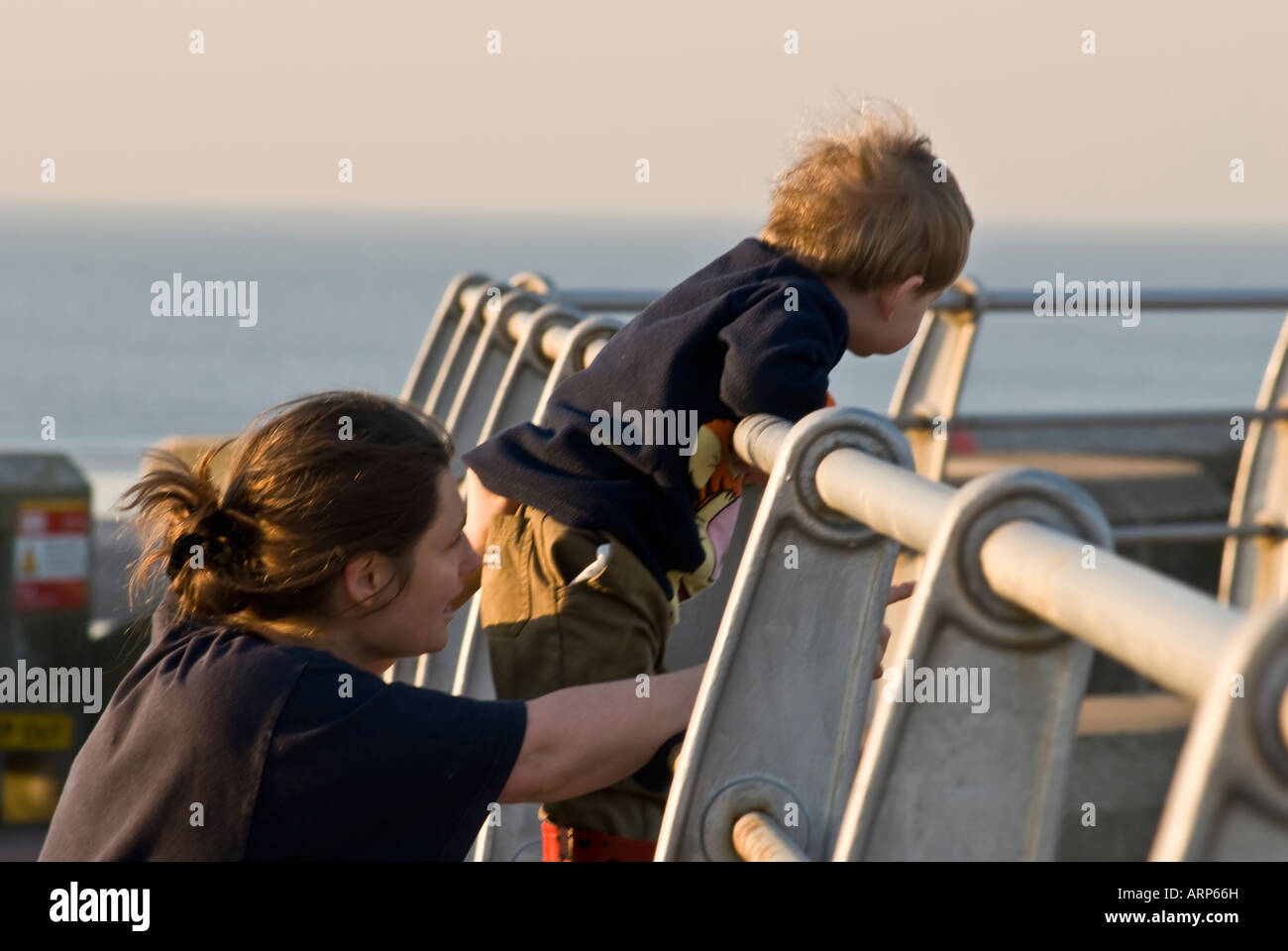 Child climbing railings Stock Photo - Alamy