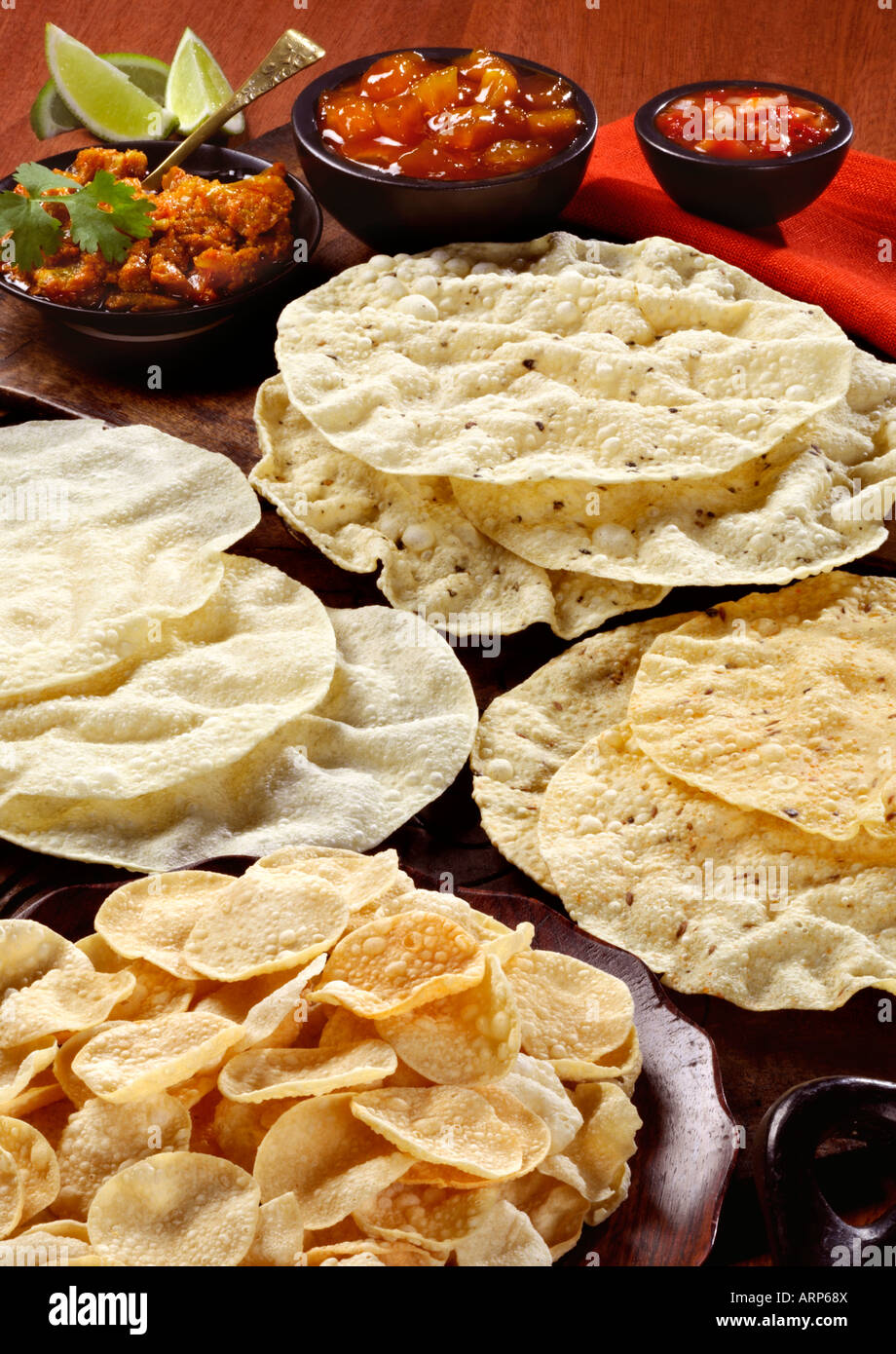 Mixed puppodums with mixed Indian dips Stock Photo - Alamy