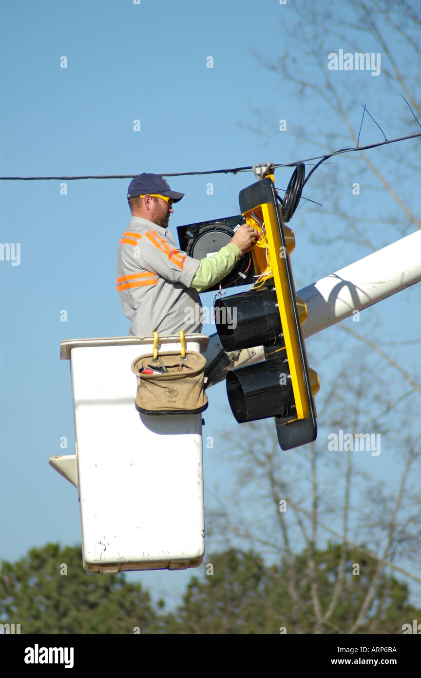Electrician working on new turn signals on highway for better traffic ...
