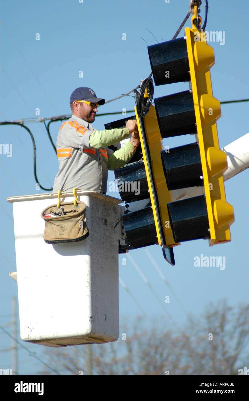 Electrician working on new turn signals on highway for better traffic ...
