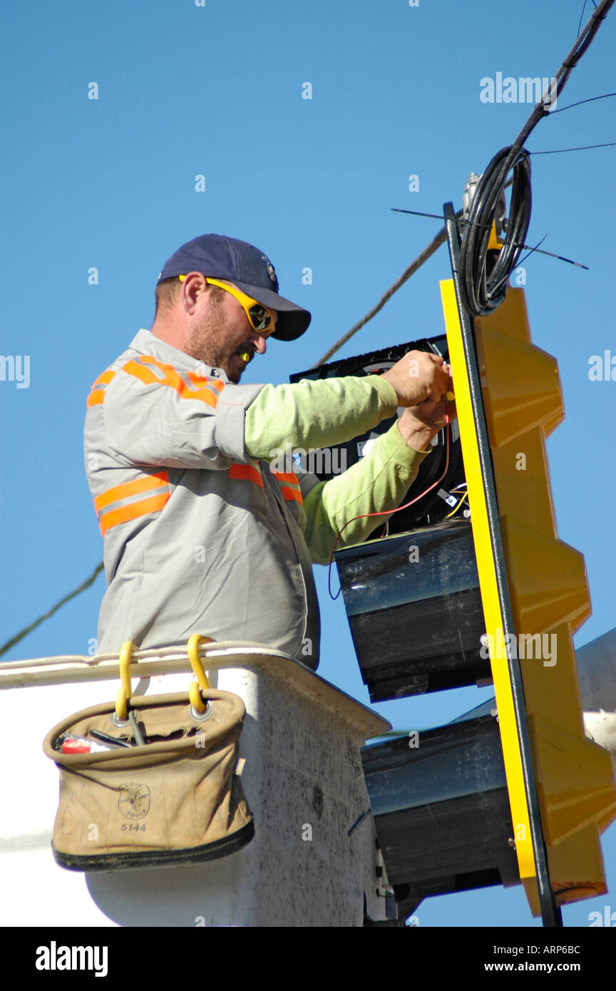 Electrician working on new turn signals on highway for better traffic ...