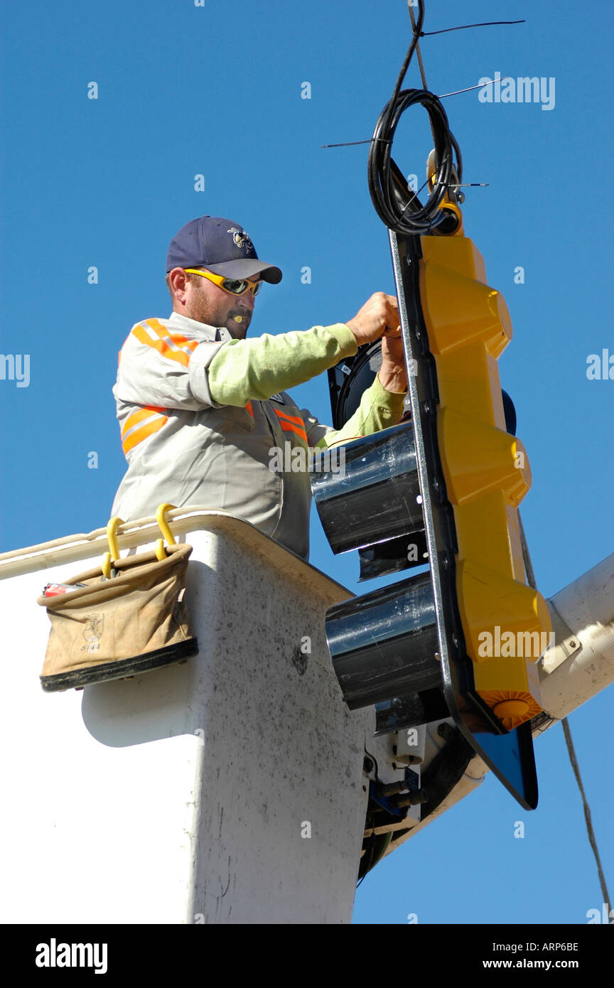 Electrician working on new turn signals on highway for better traffic ...
