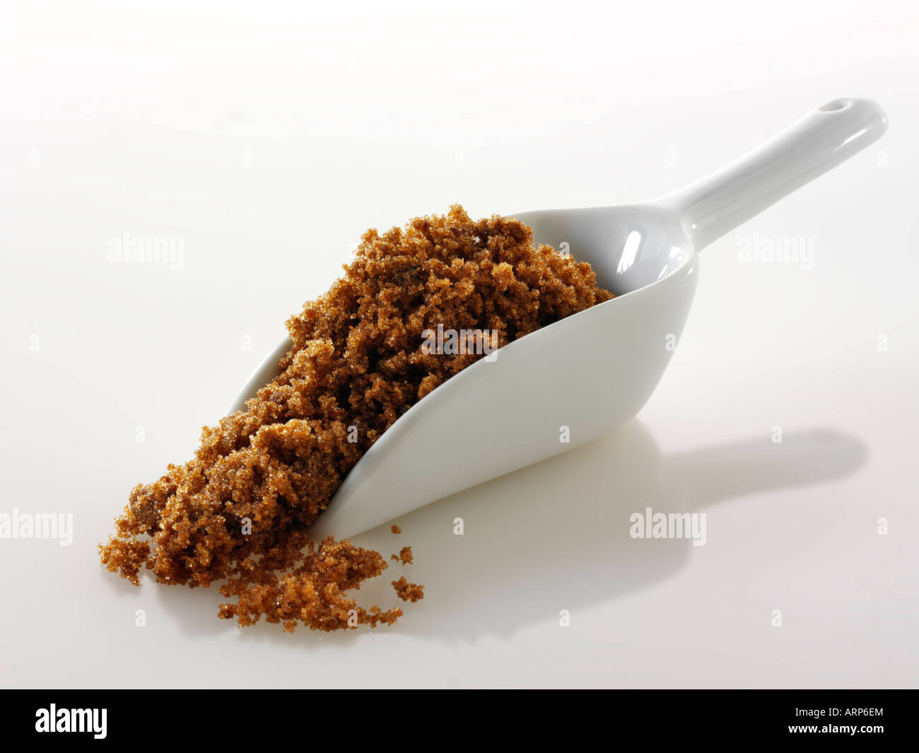 Dark Muscavado unrefined sugar still life against a white background ...